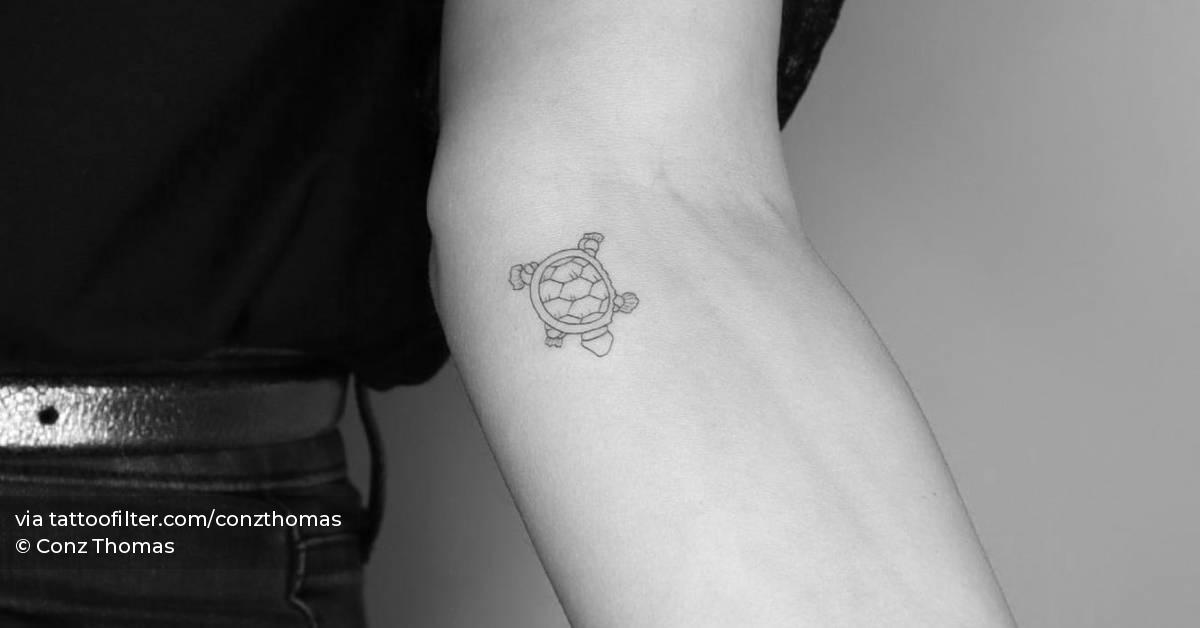 Fine line turtle tattoo done on the inner forearm.