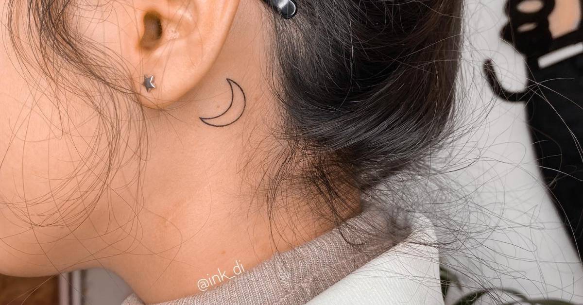 Crescent moon tattoo done behind the ear, minimalistic