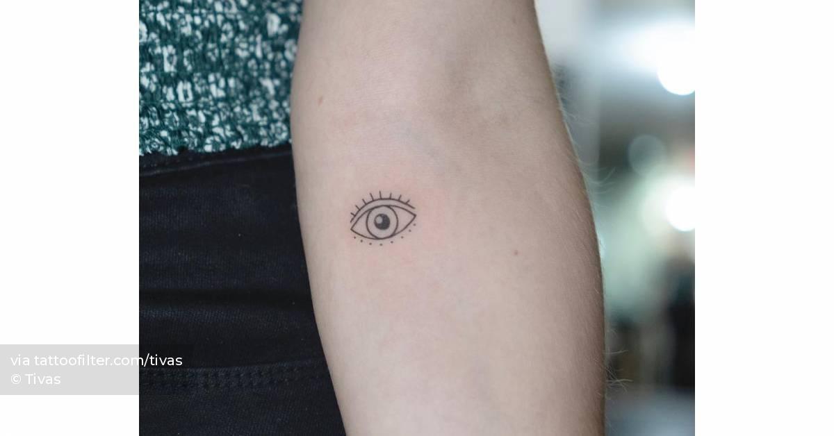 Minimalistic evil eye tattoo located on the inner