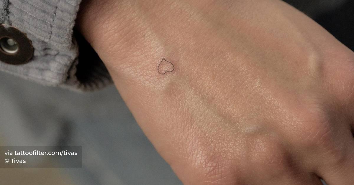 Tiny heart tattoo located on the hand.