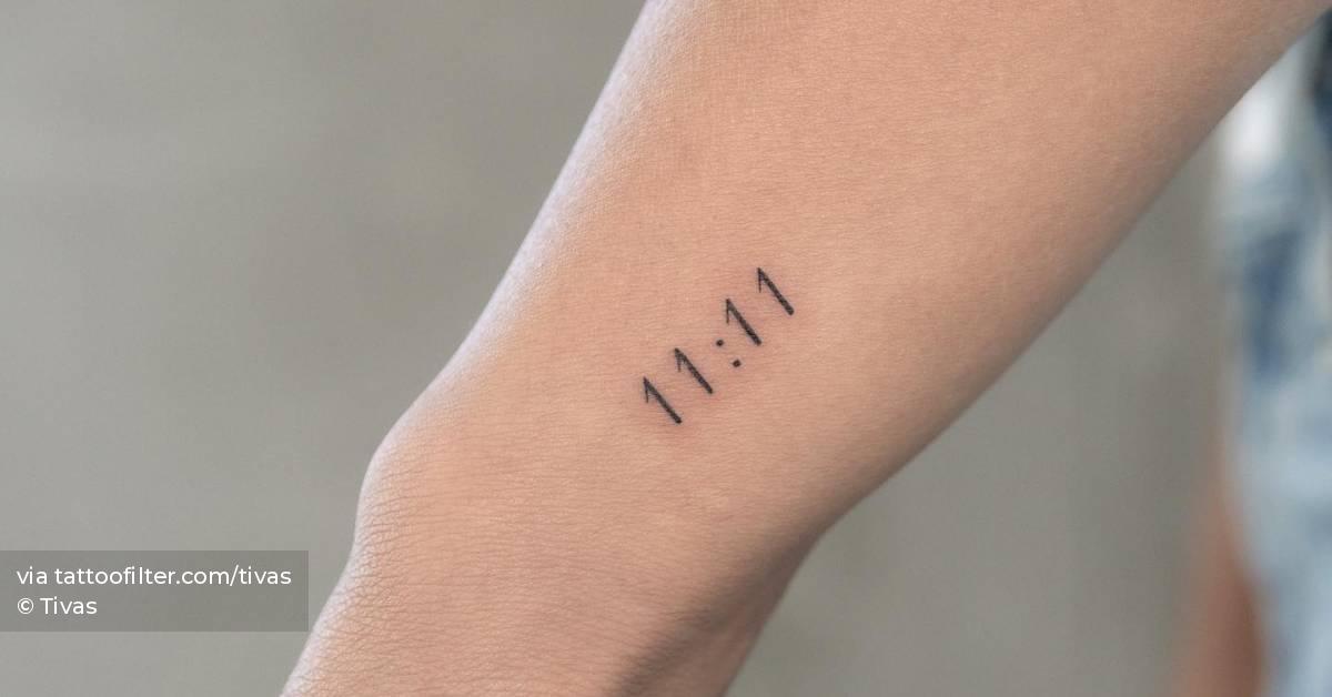 "11:11" lettering tattoo placed on the wrist.
