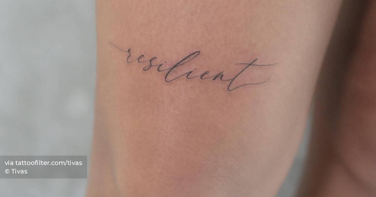Word "resilient" tattooed on the thigh.