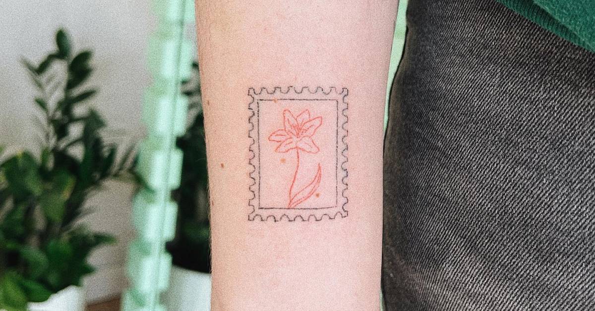Hand poked lily stamp tattoo located on the wrist.