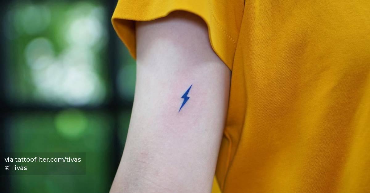 Blue lightning bolt tattoo located on the inner arm.
