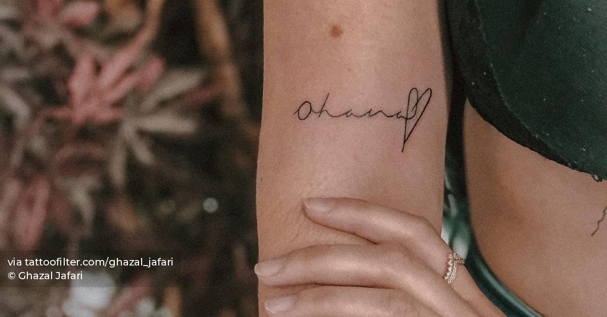 "Ohana" lettering tattoo placed on the upper arm.
