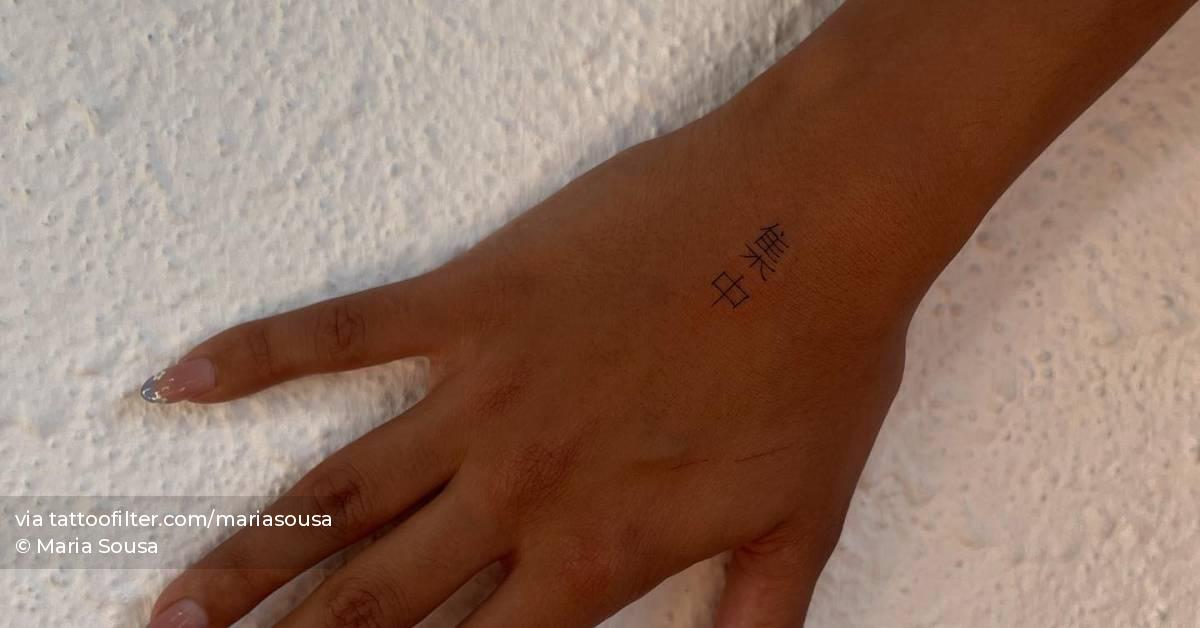Chinese characters tattooed on the hand.