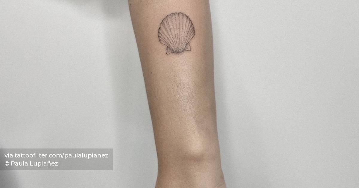 Fine line shell tattoo located on the forearm.