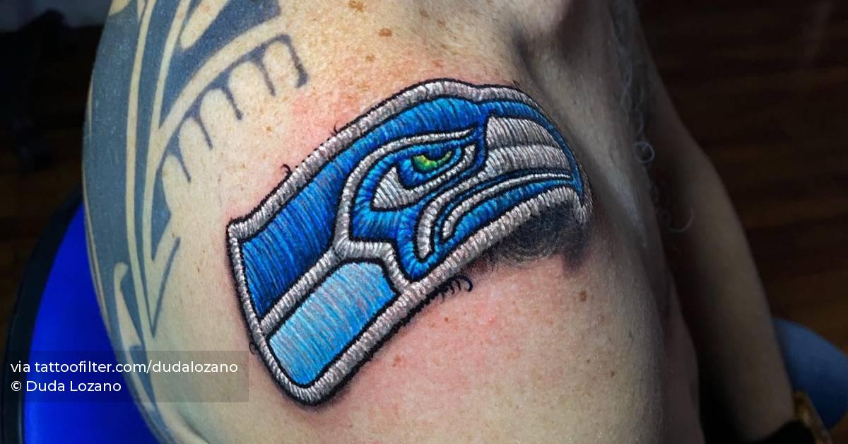 Seattle Seahawks patch tattoo located on the shoulder.