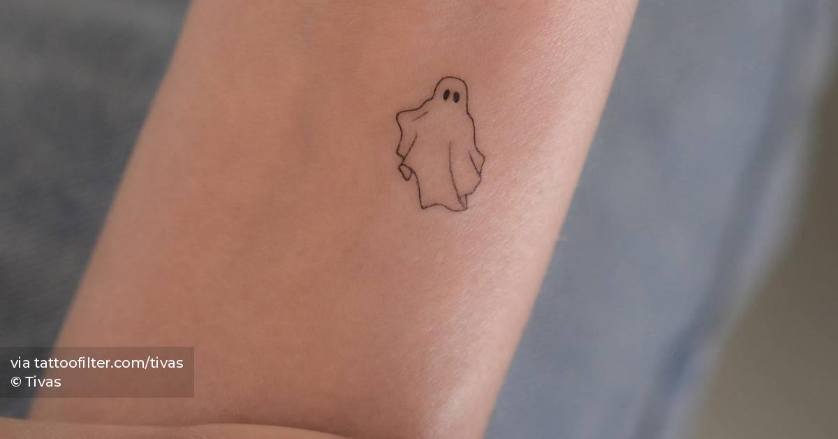 Minimalistic tiny ghost tattoo located on the wrist.