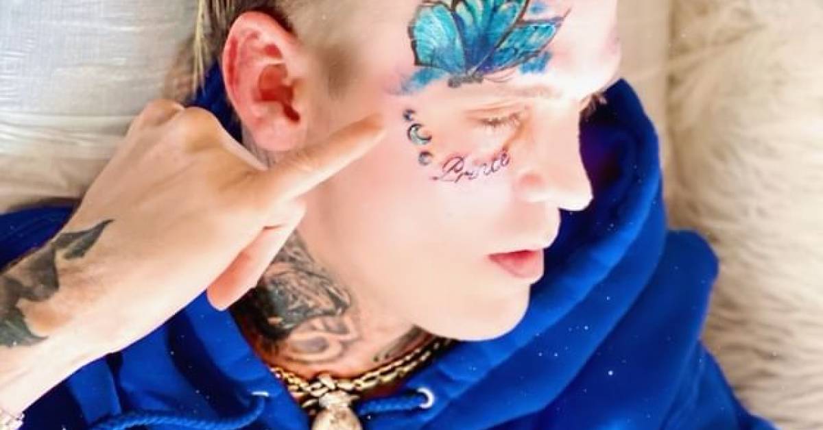 Blue butterfly tattoo located on Aaron Carter's face.