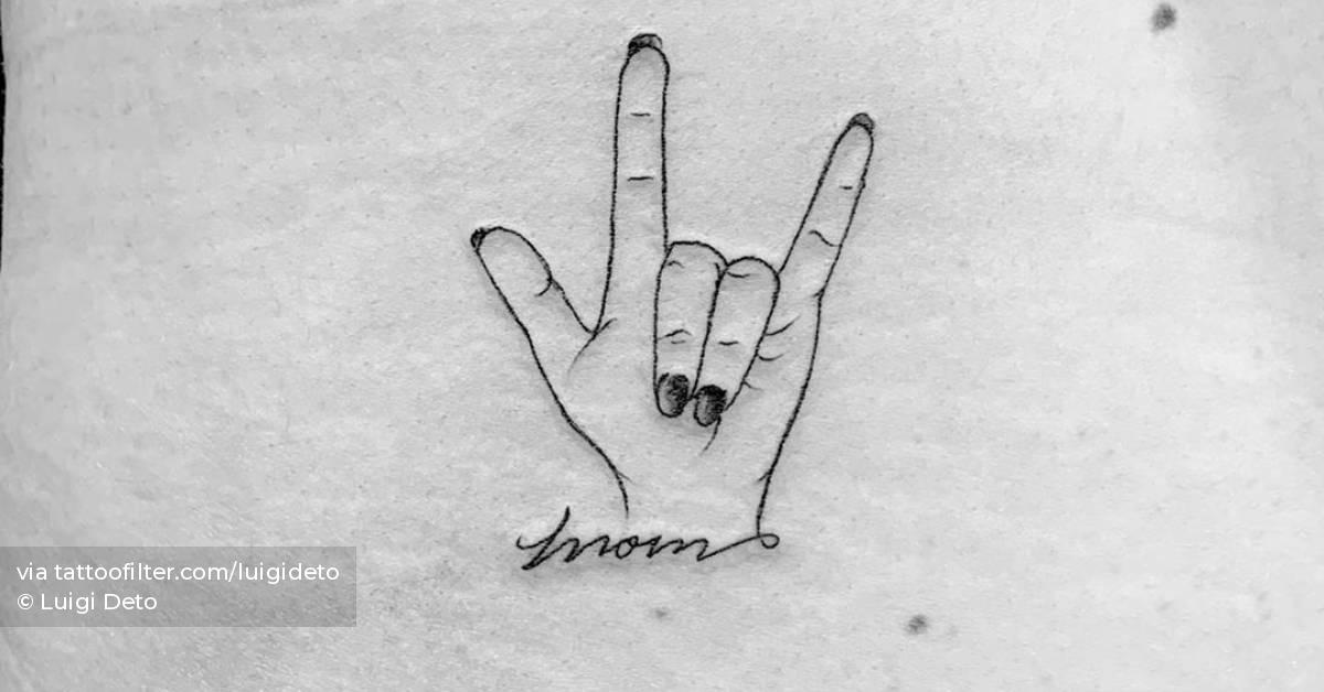 ILY sign + "mom" tattoo