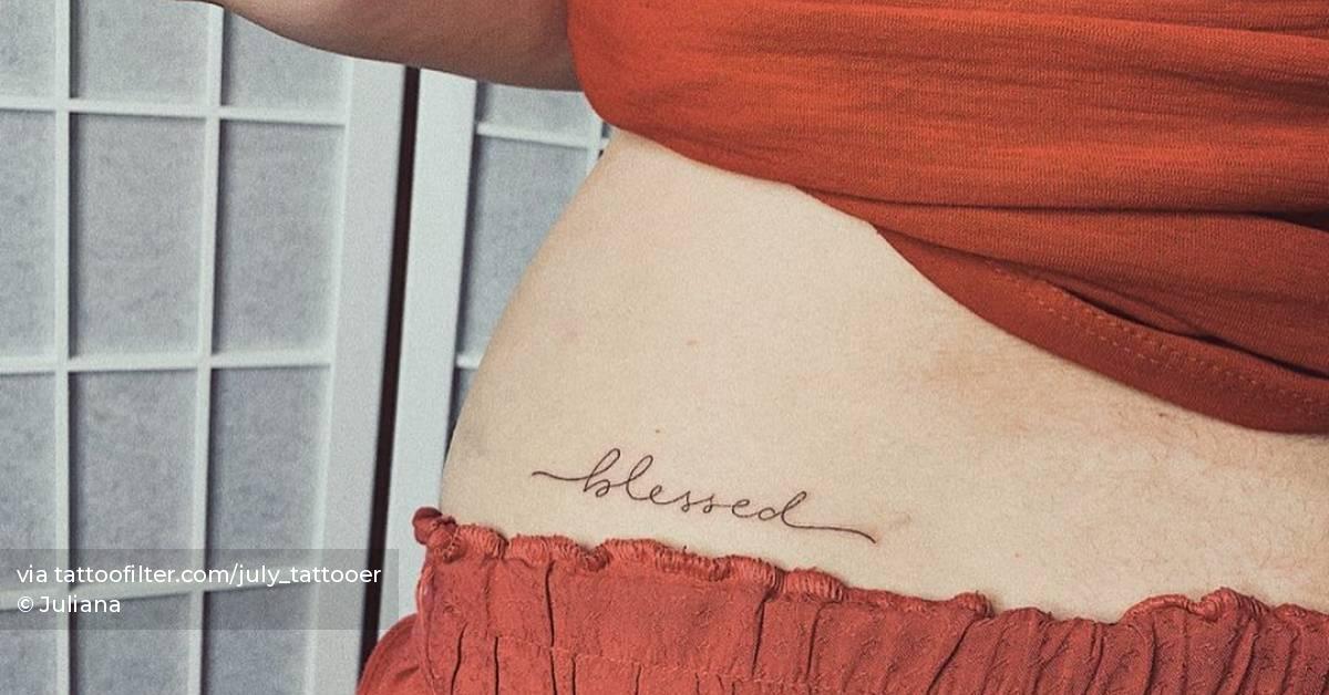 "Blessed" lettering tattoo on the hip