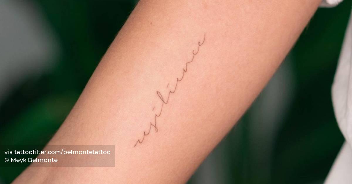 "Resilience" lettering tattoo on the inner arm