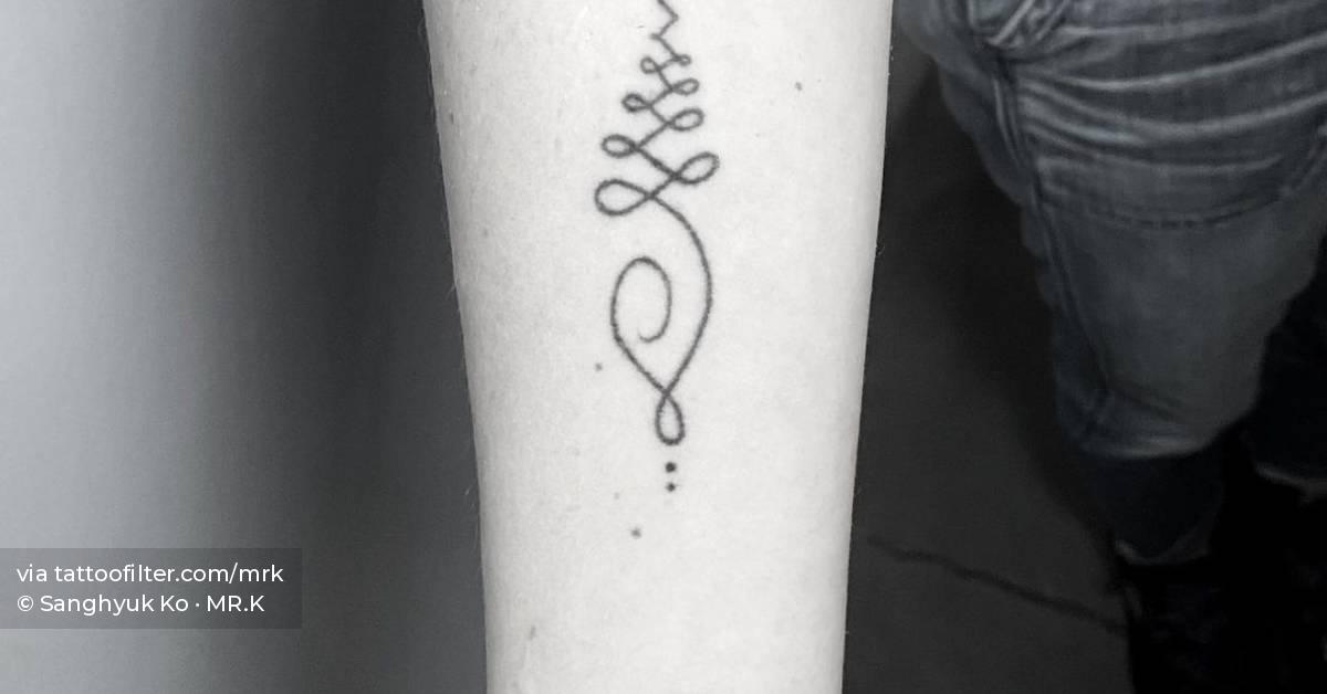 Single needle snake bracelet tattoo on the forearm.