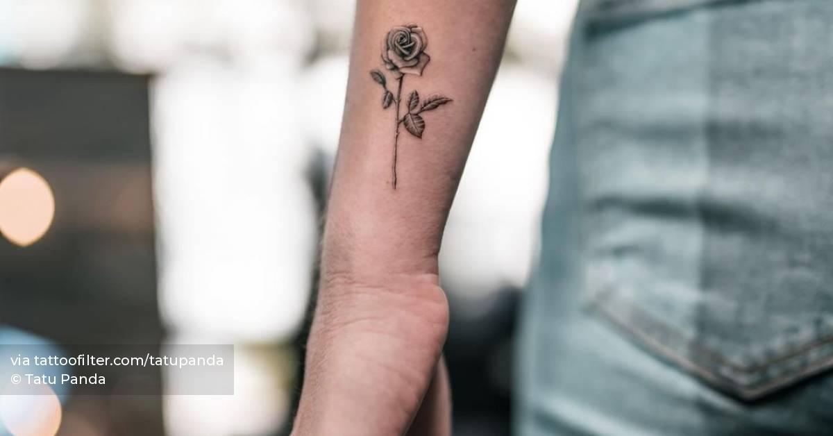 Micro-realistic rose tattoo on the wrist.