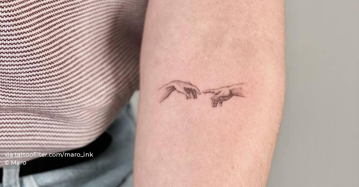 Micro-realistic "The Creation of Adam" hands tattoo on