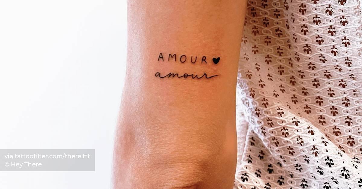 Tattoo of the word "amour" located on the tricep.