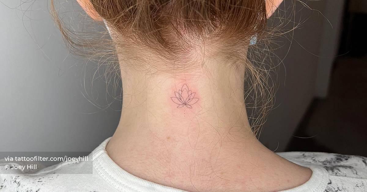 Fine line lotus flower tattoo located on the back of