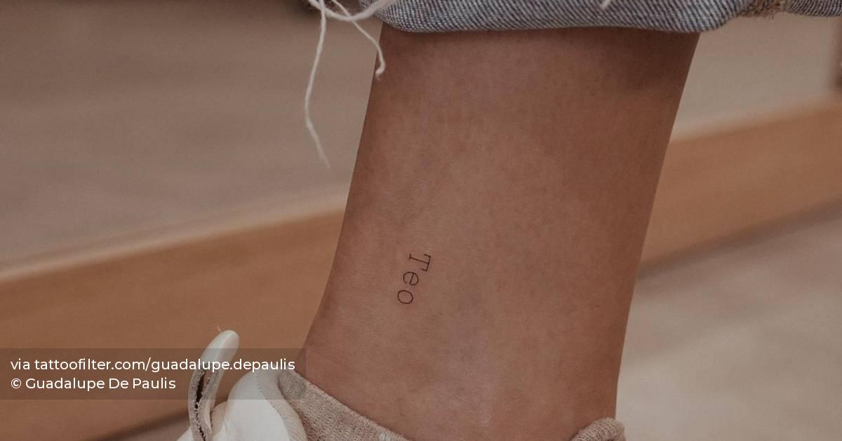 "Teo" lettering tattoo located on the ankle.