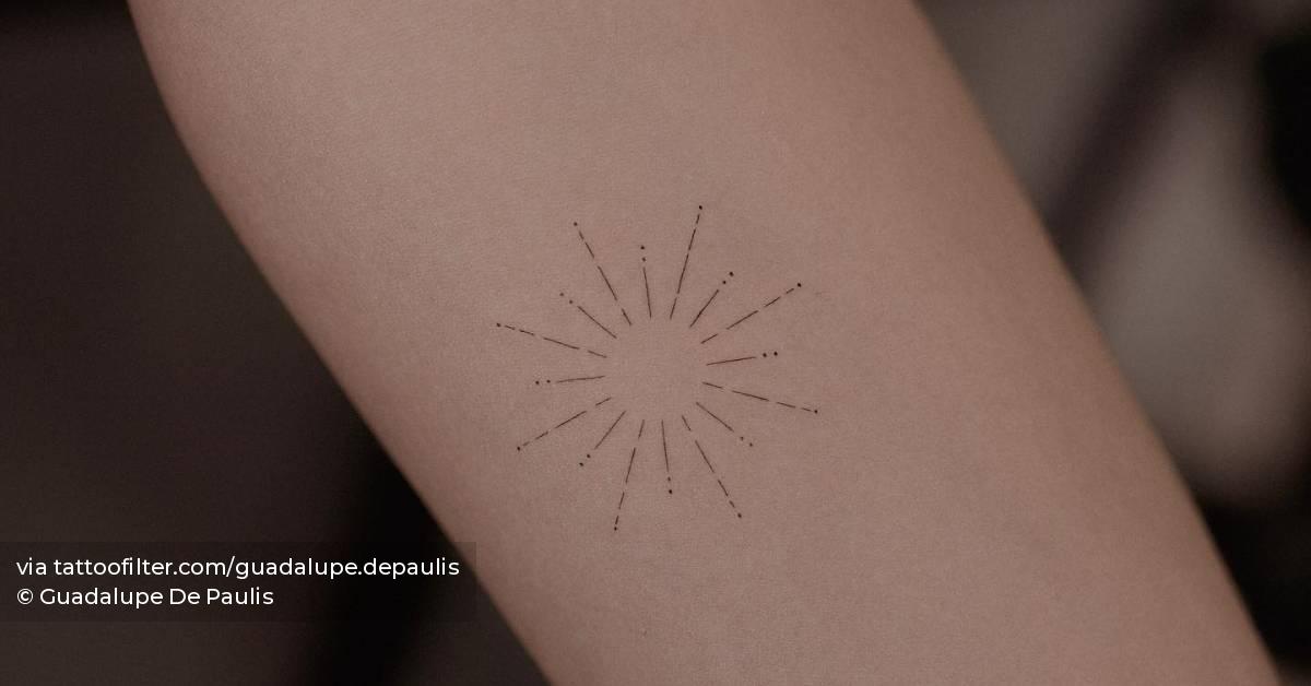 Fine line sun tattoo located on the inner forearm.