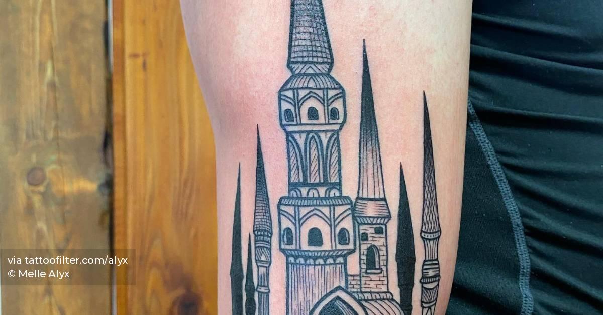 Engraving style castle tattoo located on the upper arm.