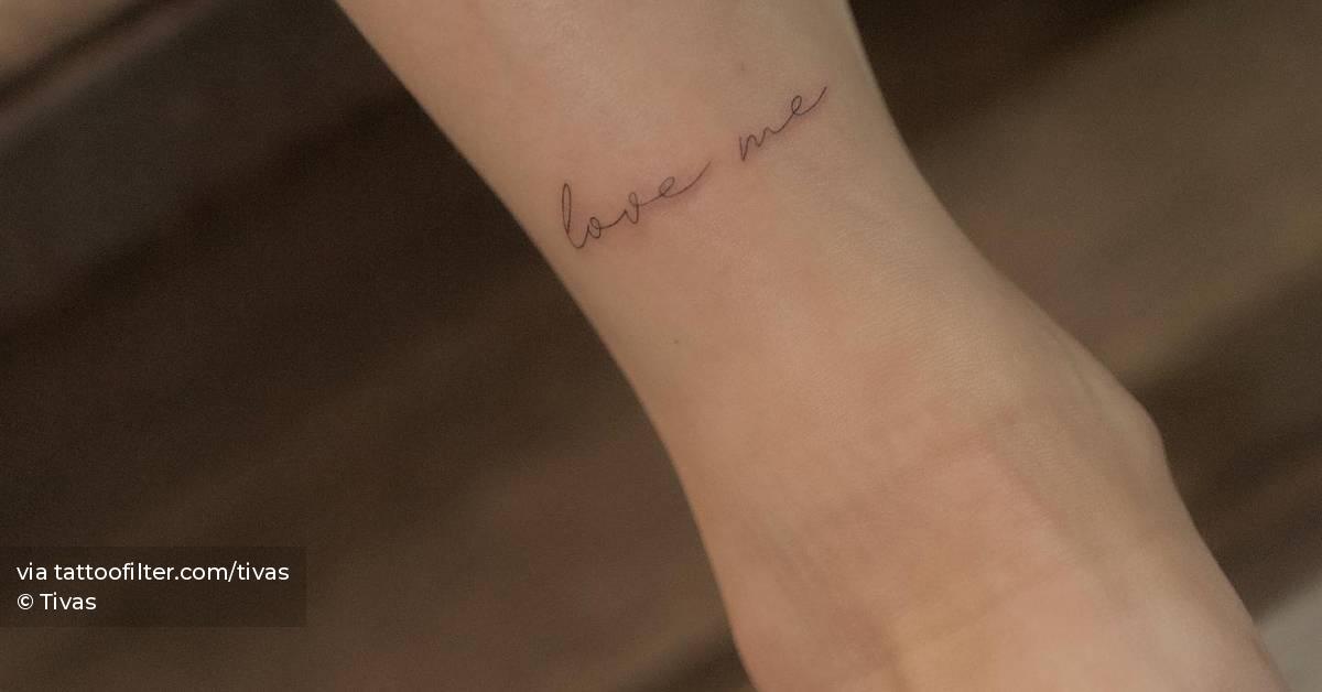 "Love me" lettering tattoo handwritten on the shin.