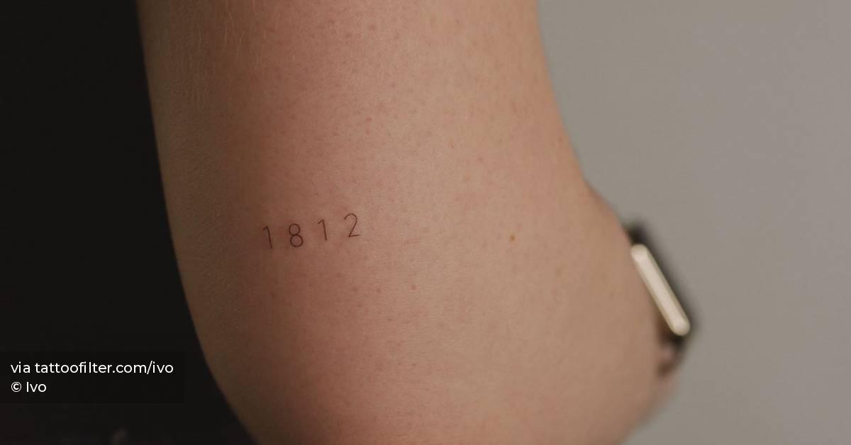 "1812" lettering tattoo located on the tricep.