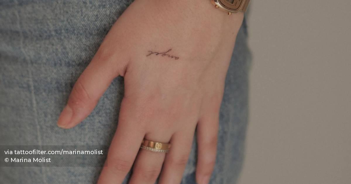 Word "angel" tattooed on the hand.