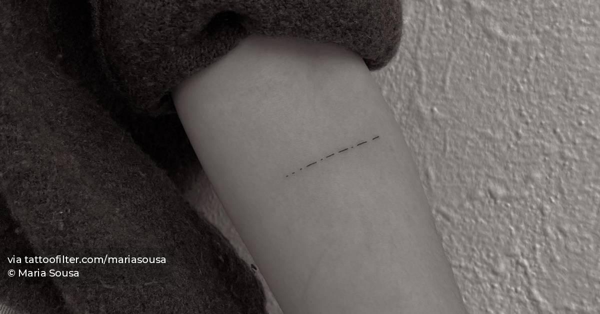 Minimalistic style morse code tattoo located on the