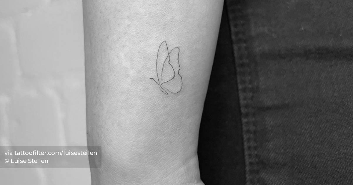 Delicate butterfly tattoo in fine line style, located