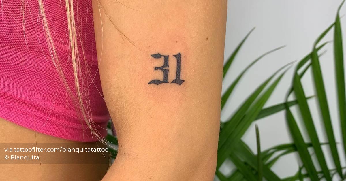 Tattoo of the number "31" located on the upper arm.