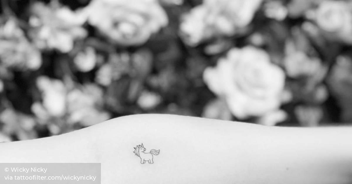 Minimalist unicorn tattoo on the inner forearm.