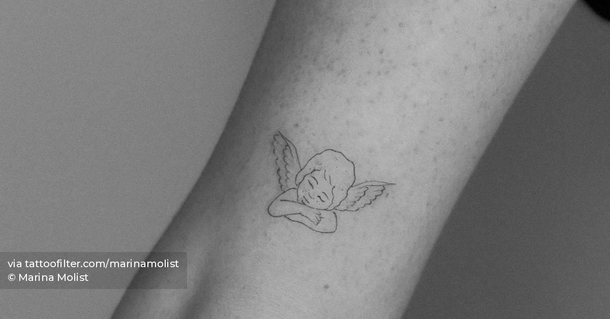 Fine line cherub tattoo done on the tricep.