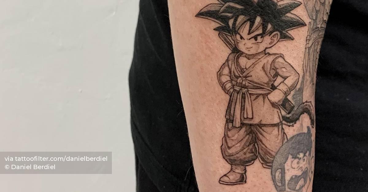 Goku tattoo done on the forearm, cartoon style.