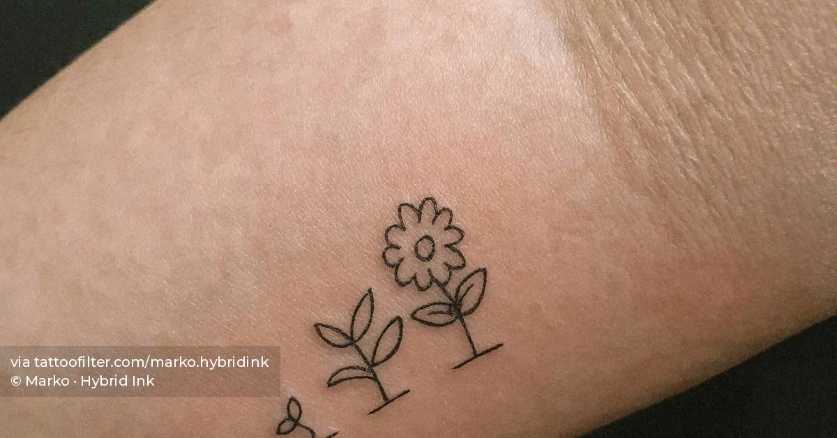 Minimalistic blooming flower tattooed on the inner