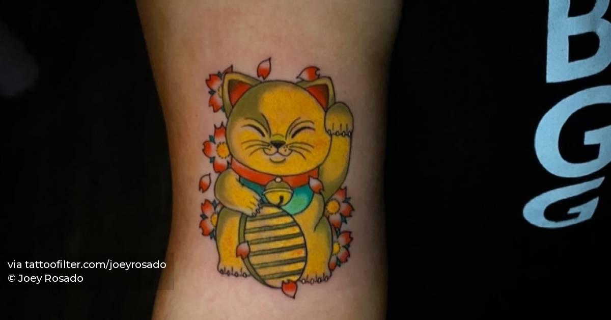 Maneki-Neko tattoo located on the bicep.