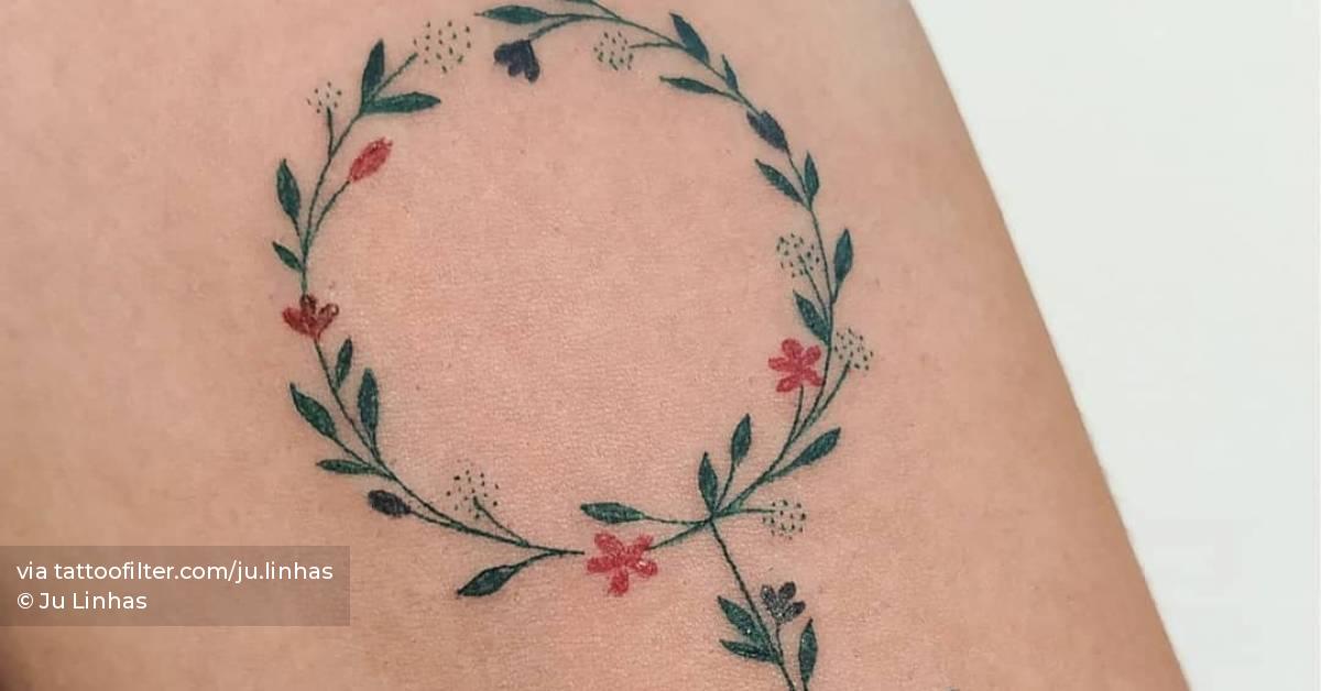 Floral venus symbol tattoo done on the inner forearm.