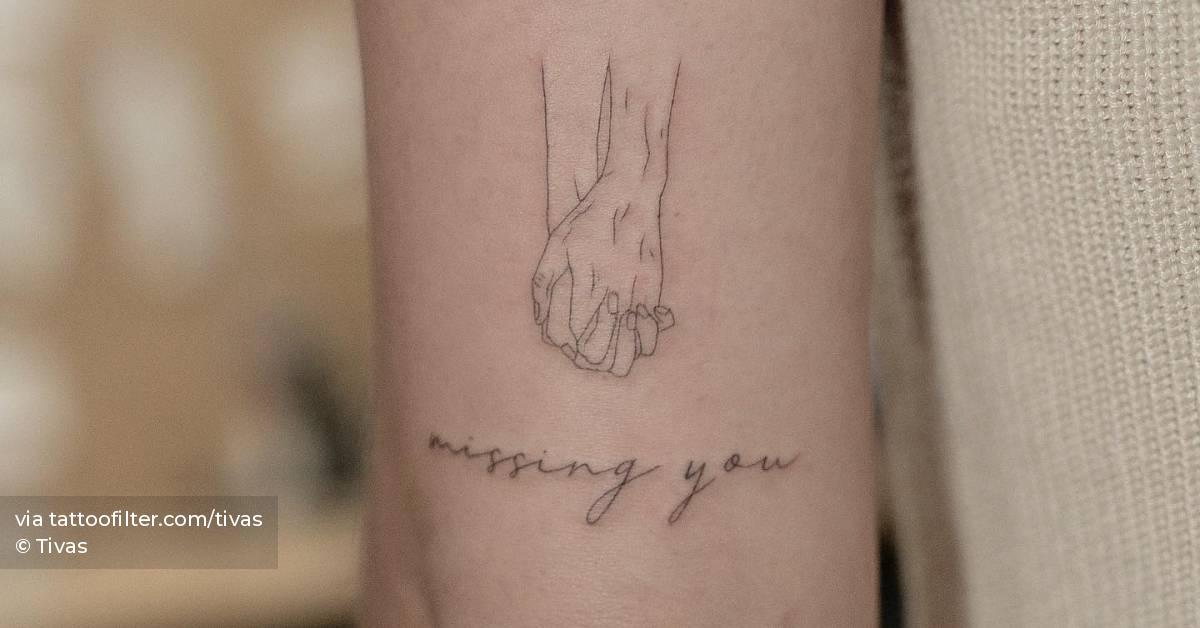 "Missing you" and holding hands tattoo located on the