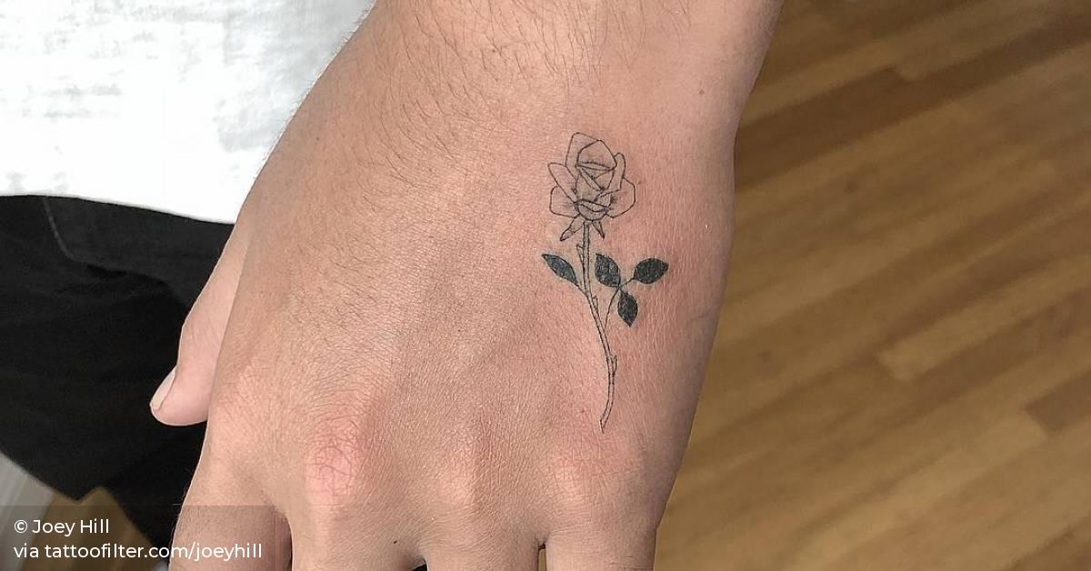 Fine line rose tattoo on the left hand.