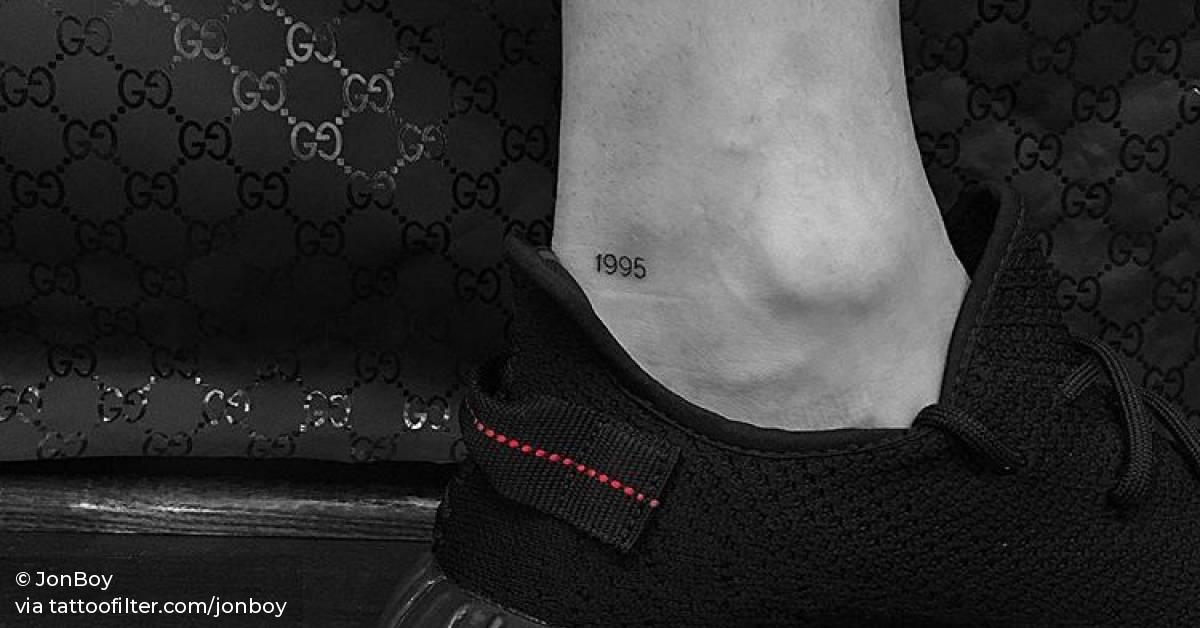 1995 tattoo on the ankle.