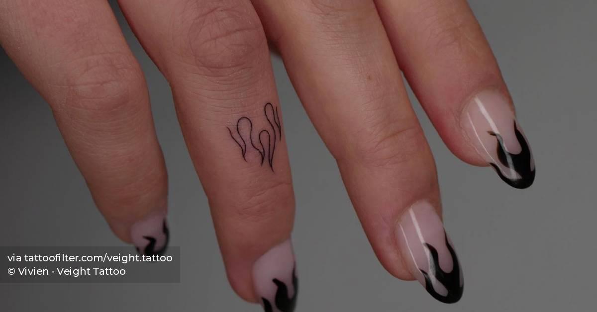 Minimalistic style fire tattoo done on the finger.