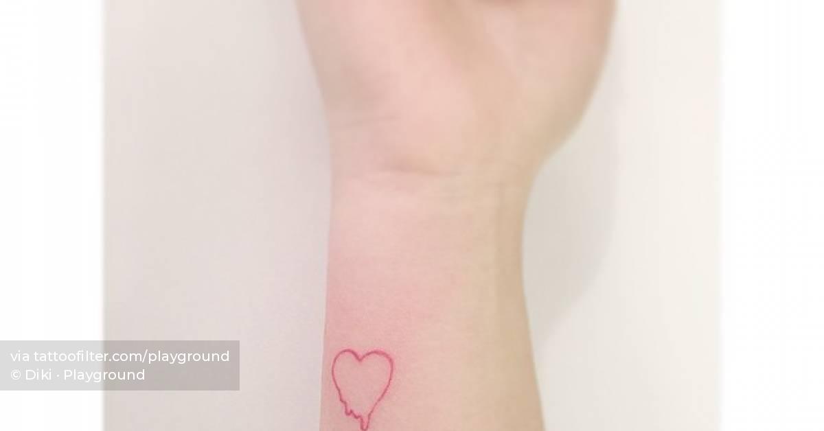 Minimalistic style red heart tattoo done on the wrist.