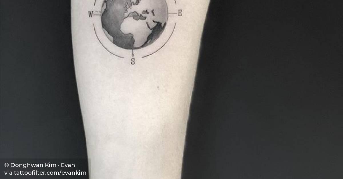 Planet earth compass tattoo on the left inner forearm.