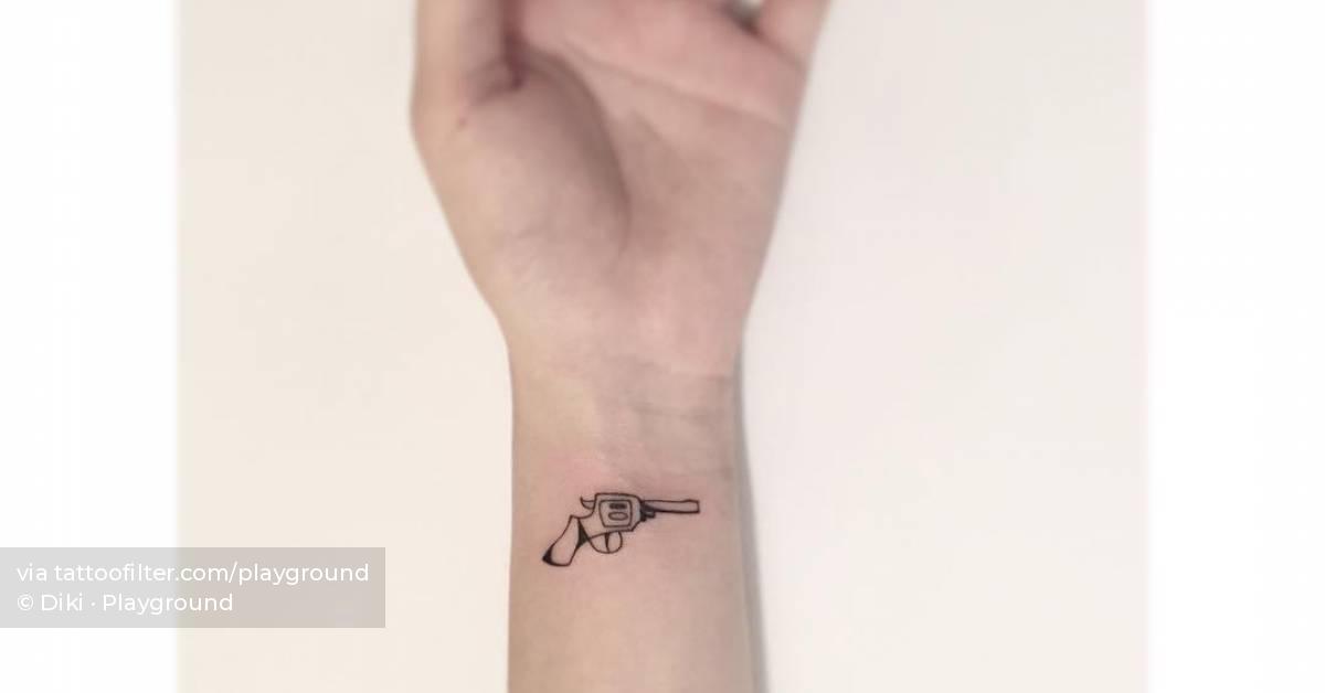 Minimalistic revolver tattoo done on the wrist.