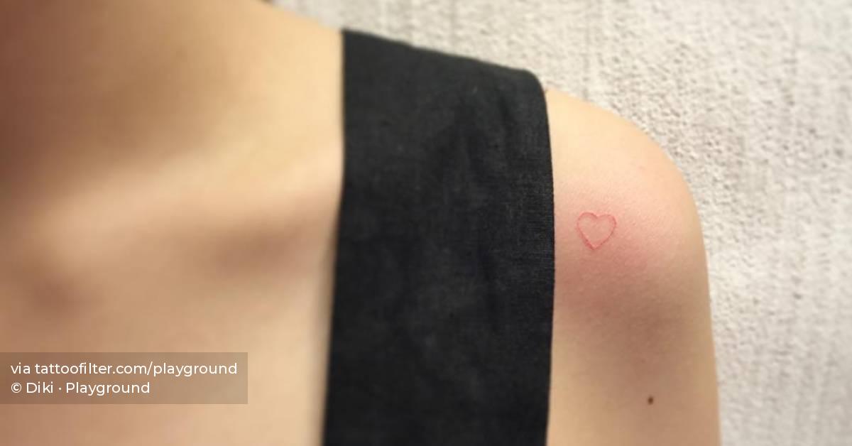 Tattoo of a red heart placed on the shoulder.