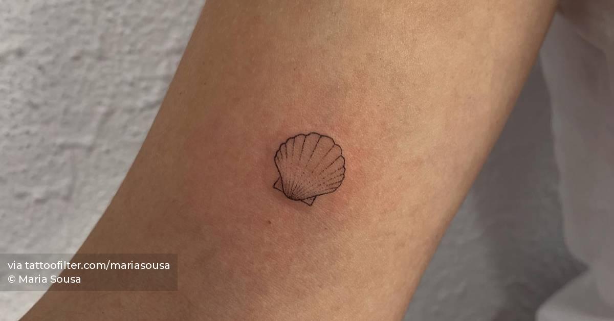Fine line shell tattoo done on the inner arm.