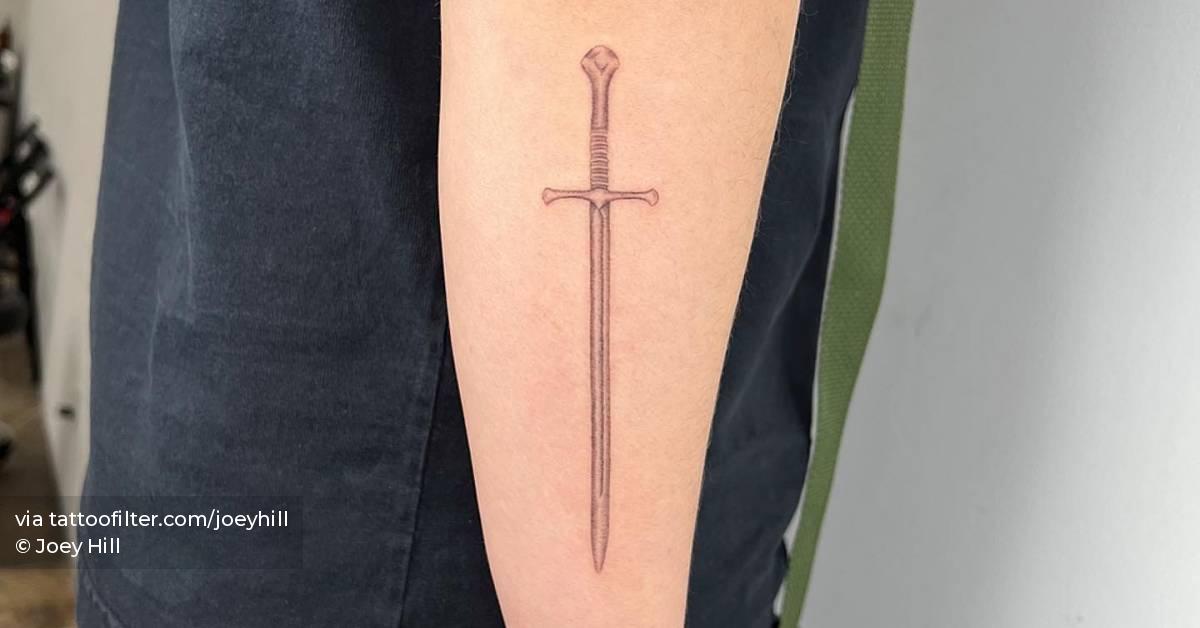 Micro-realistic sword tattoo located on the forearm.