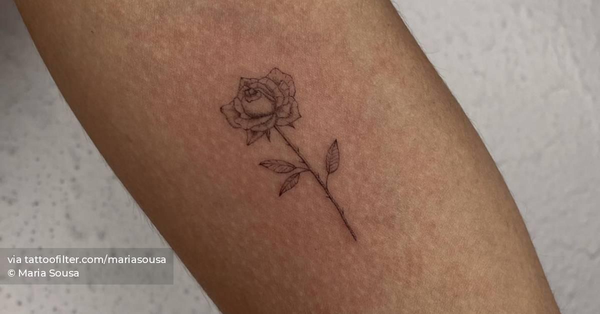 Fine line rose tattoo located on the inner arm.