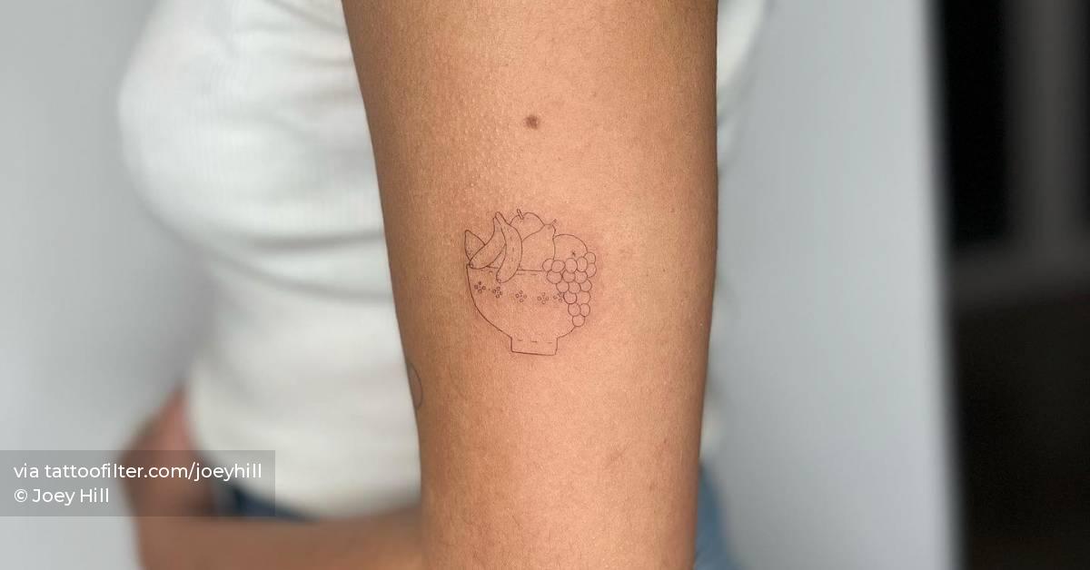 Single needle still life tattoo located on the upper