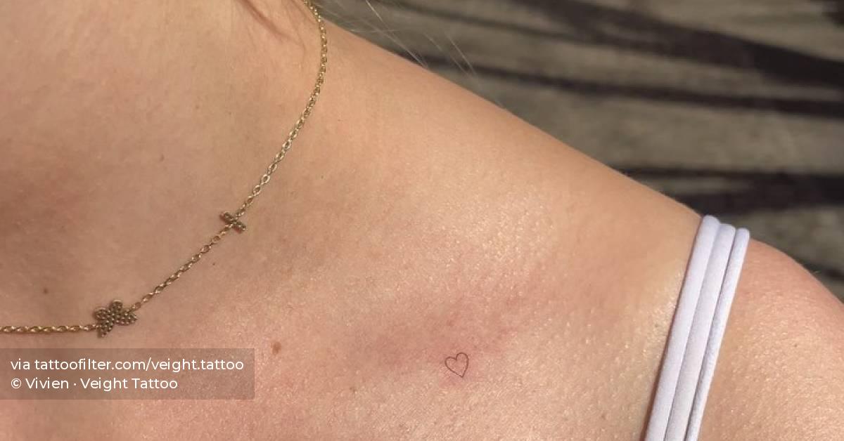Micro heart tattoo located on the collarbone,